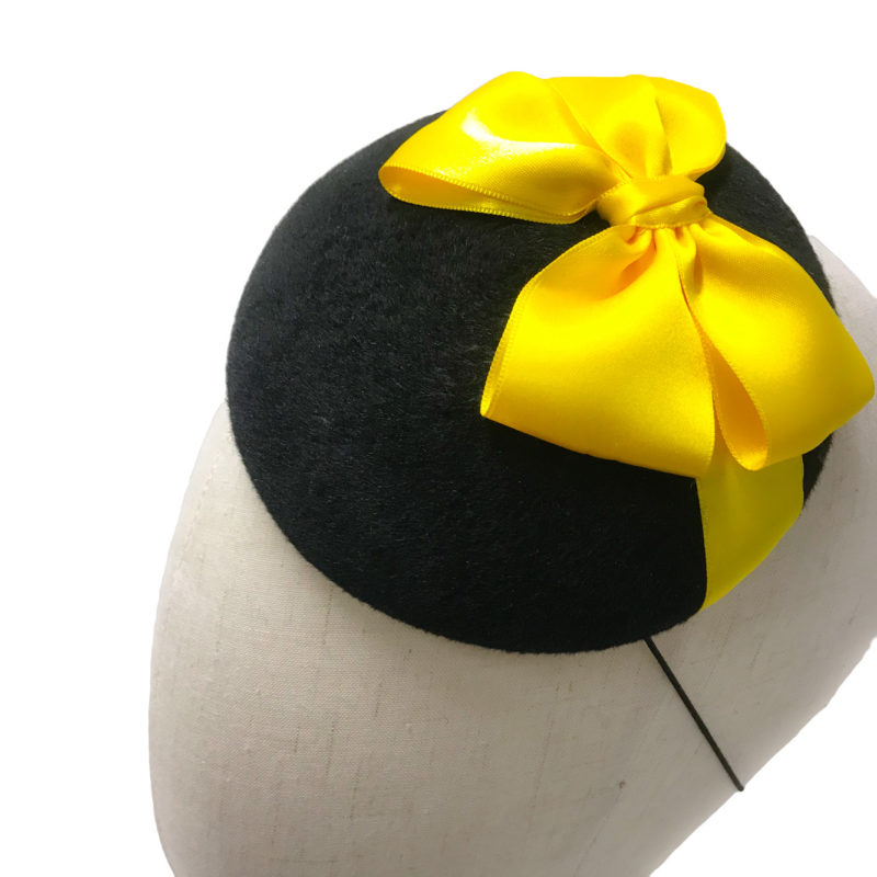 Cocktailhattu, musta huopa ja keltainen rusetti